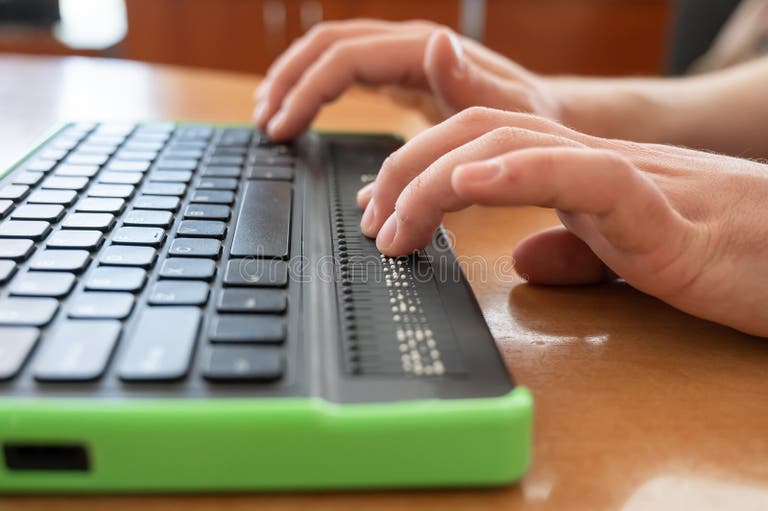 A Blind Man Uses a Computer with a Braille Display and a Computer ...