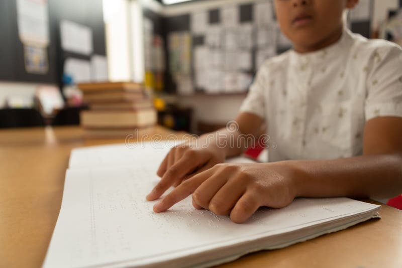 Blind Schoolboy Reading a Braille Book in Classroom Stock Photo - Image ...
