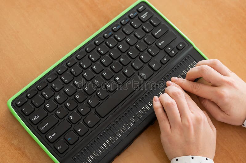 A Blind Man Uses a Computer with a Braille Display and a Computer ...