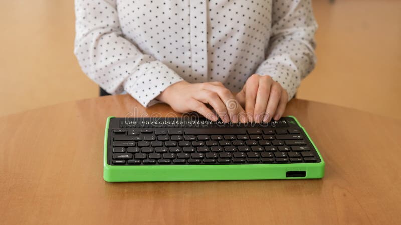 A Blind Woman Uses a Computer with a Braille Display and a Computer ...