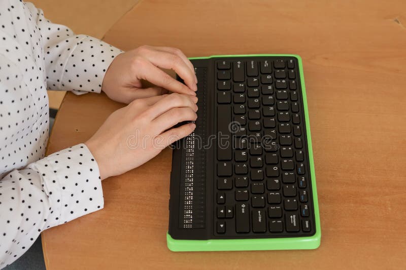A Blind Man Uses a Computer with a Braille Display and a Computer ...