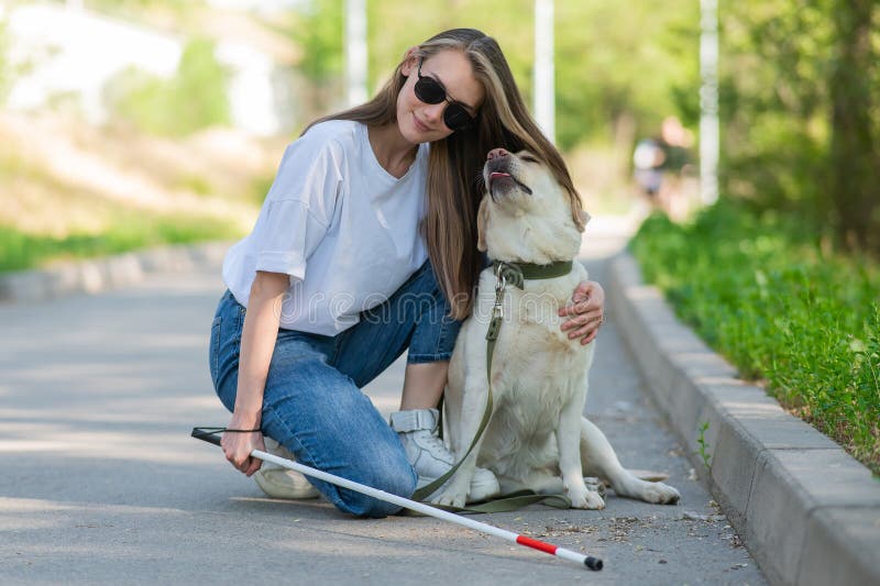 Blind Young Woman Cuddling with Guide Dog on a Walk Outdoors. Stock ...