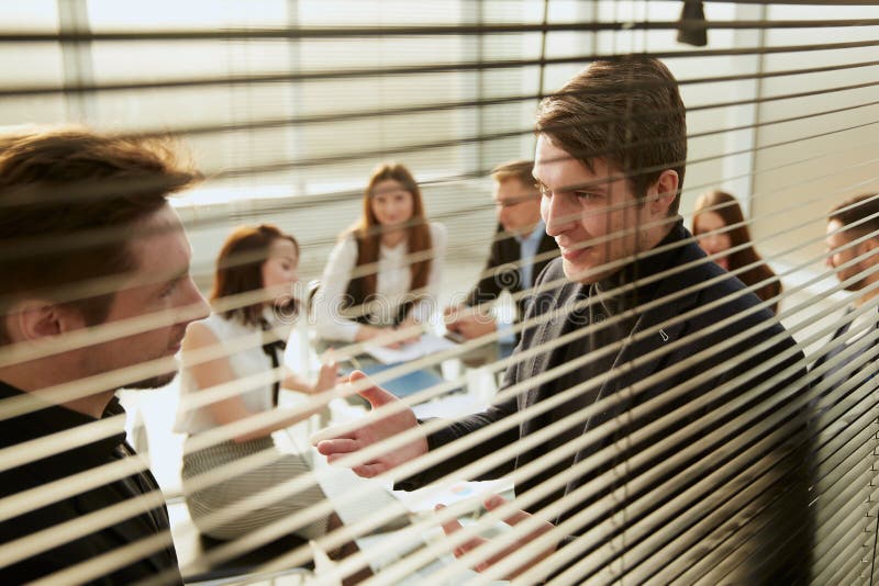 Through the Blinds. Business Colleagues Discussing Work Issues Stock ...
