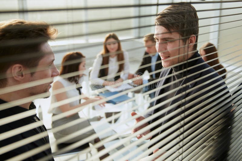Through the Blinds. Business Colleagues Discussing Work Issues Stock ...