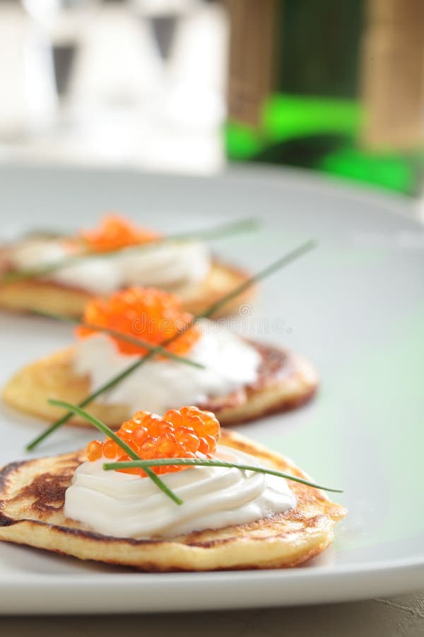 Blinis with Red Caviar and Sour Cream Decorated with Green Onion Stock ...