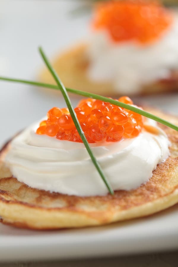 Blinis with Red Caviar and Sour Cream Decorated with Green Onion Stock ...