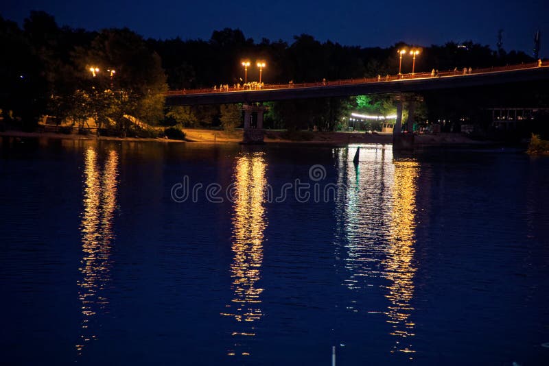 Blinking Lights on Night Bridge, Sparkle in Water Reflection Stock ...