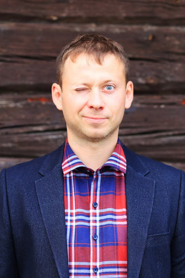Blinking Man in Blue Jacket and Checkered Shirt Stock Photo - Image of ...