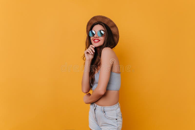 Blissful Young Woman With Red Lips Sensually Posing On Yellow