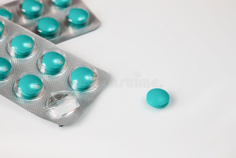 Blisters of Green Pills and Separately One Pill on a White Background ...