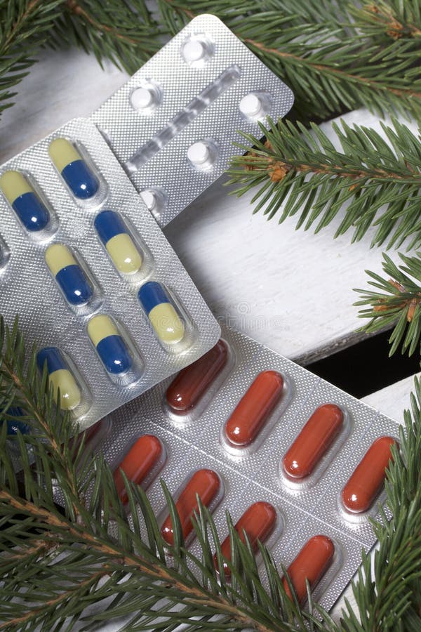 The Blisters with Pills. Different Colors. Spruce and Pine Branches ...