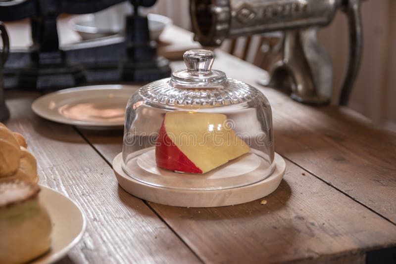 A Block of Cheese Under a Cheese or Cake Dome Stock Photo - Image of ...