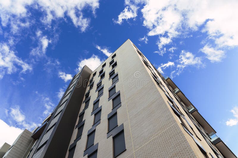 Block of Tall Residential Buildings with Clouds in the Background at ...
