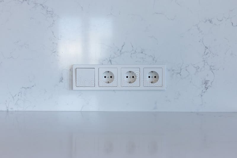 Block of Three Sockets and a Switch on a White Wall Stock Photo - Image ...