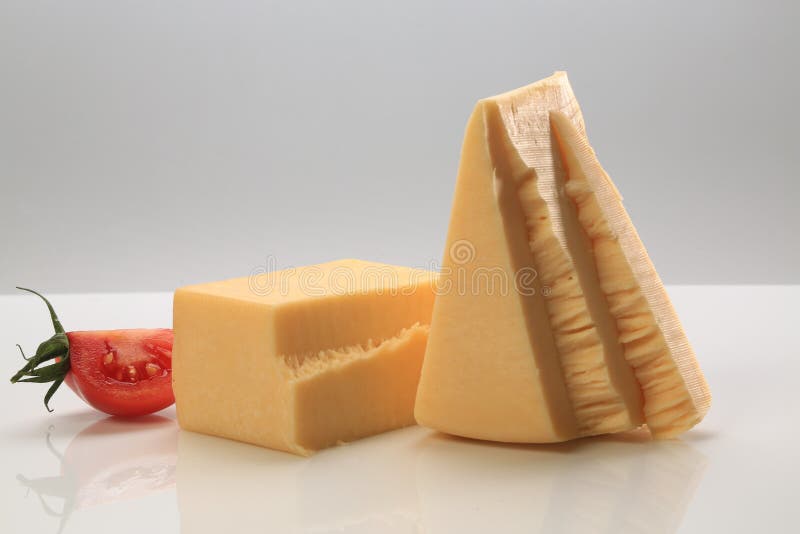 Block and Triangle Sliced Cheese with a Slice of Tomato Stock Image ...