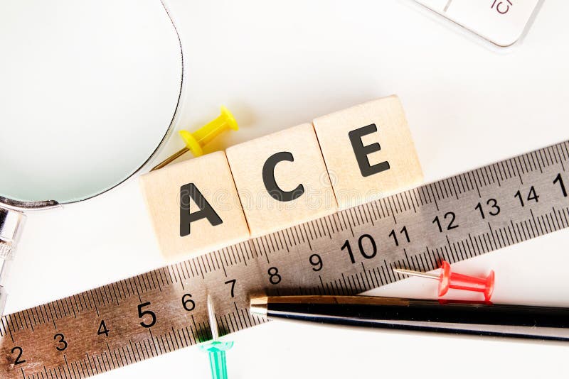 Blocks with Letters Forming ACE Sit Next To a Ruler, Magnifying Glass ...