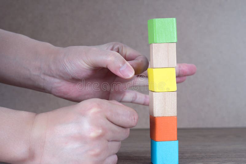 Blocks Stacked Up by Flicking by Hand Stock Photo - Image of hands ...