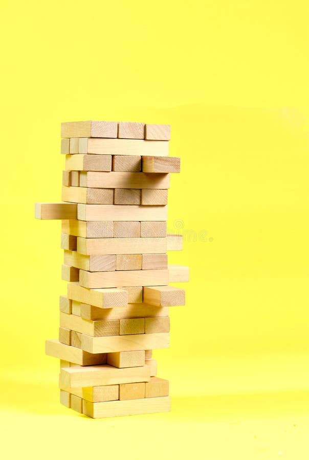 Blocks of the Wooden Game Jenga on a Yellow Background, Space for Text ...