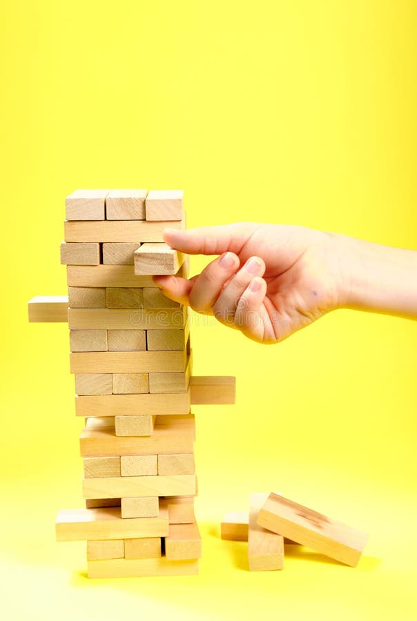 Blocks of the Wooden Game Jenga on a Yellow Background, Space for Text ...