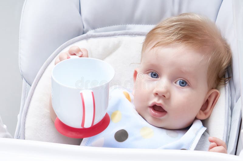 Blond Baby Eats First Lure. Holding a Drinker Close Up Stock Image ...