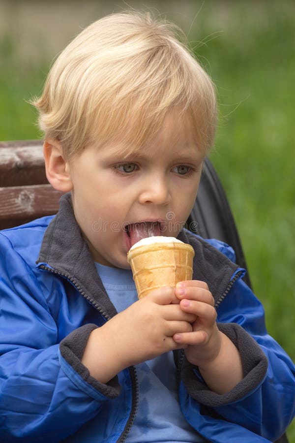 Blond boy eating ice cream stock image. Image of lifestyles - 71825805