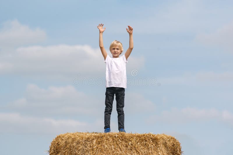 Blond Boy with Hands Up on Blue Sky Background. Cute Schoolboy Stays on ...