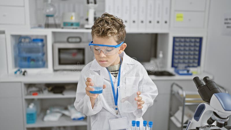 Blond Boy Scientist Doing Experiment at Laboratory Stock Photo - Image ...