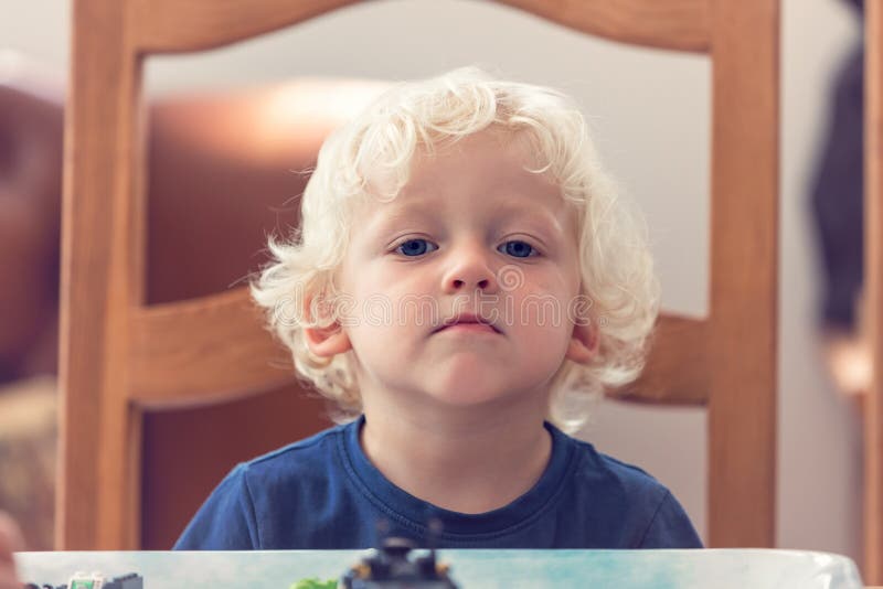 Blond boy at the table stock photo. Image of matte, development - 156380824