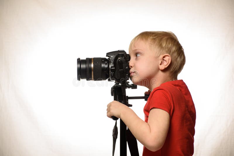 Blond Boy Takes Pictures with a SLR Camera. Side View. White Background ...