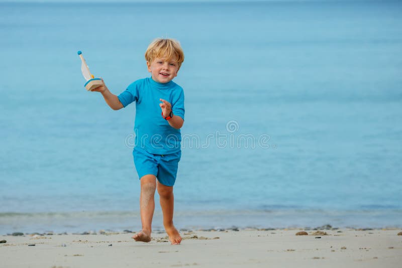 Blond Boy Walk with Boat Toy Model at the Beach Stock Image - Image of ...