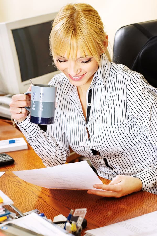 Blond Businesswoman Checking the Papers in Office Stock Photo - Image ...