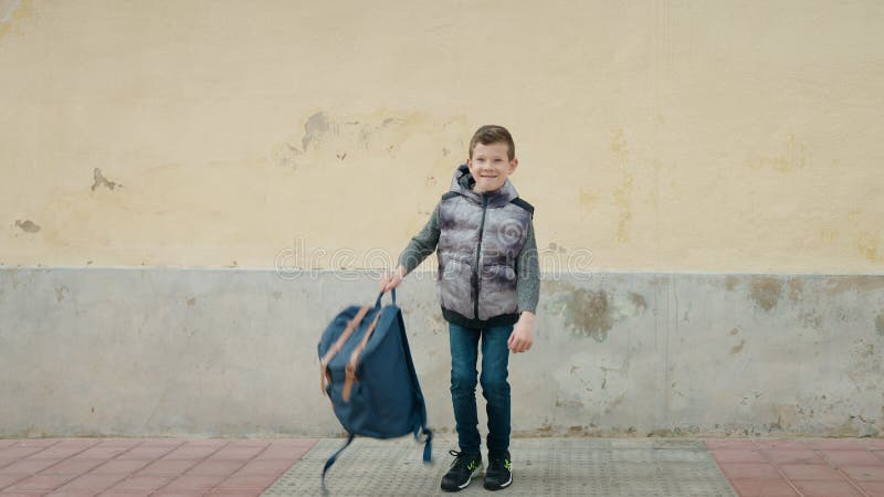 Blond Child Holding Backpack Jumping at Street Stock Footage - Video of ...