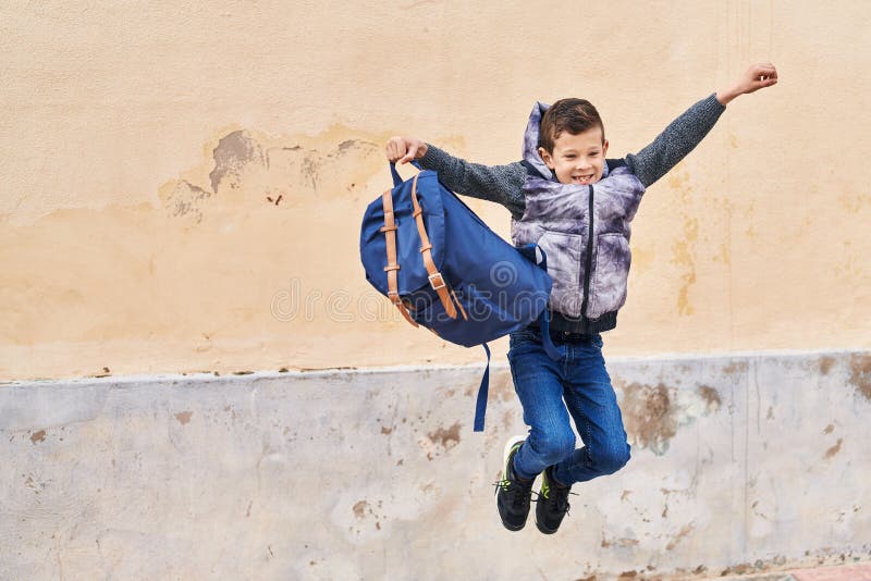 Blond Child Holding Backpack Jumping at Street Stock Photo - Image of ...