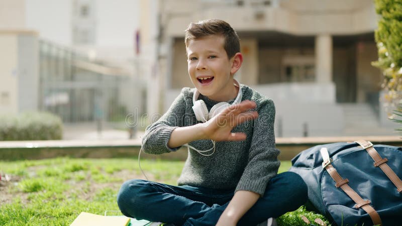 Blond Child Saying Hello Sitting on Grass at Park Stock Footage - Video ...