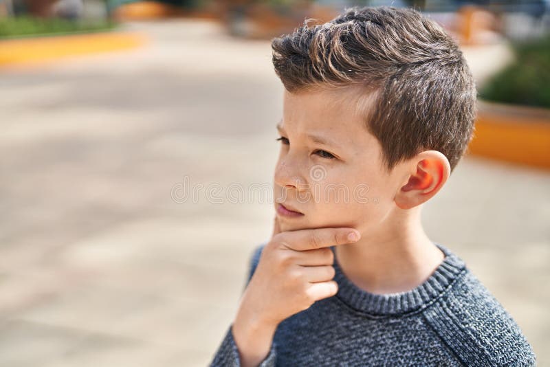 Blond Child Standing with Doubt Expression at Park Stock Image - Image ...