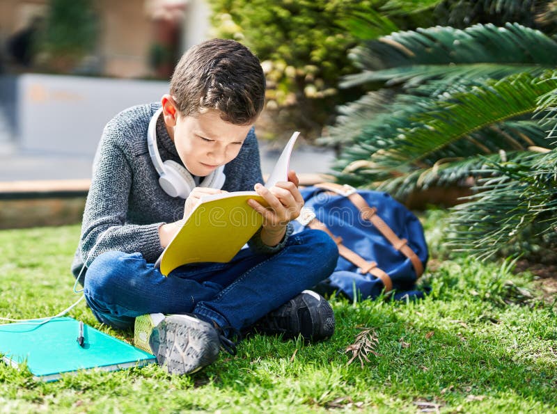 Blond Child Student Reading Book Sitting on Grass at Park Stock Image ...