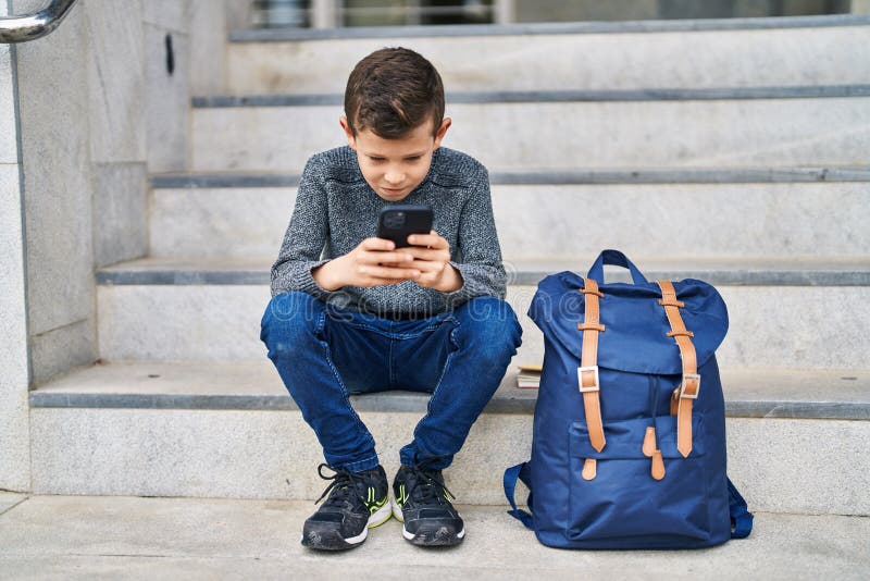 Blond Child Student Using Smartphone Sitting on Stairs at School Stock ...