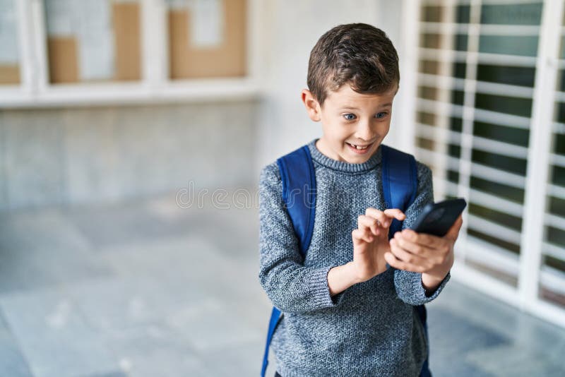 Blond Child Student Using Smartphone Standing at School Stock Photo ...