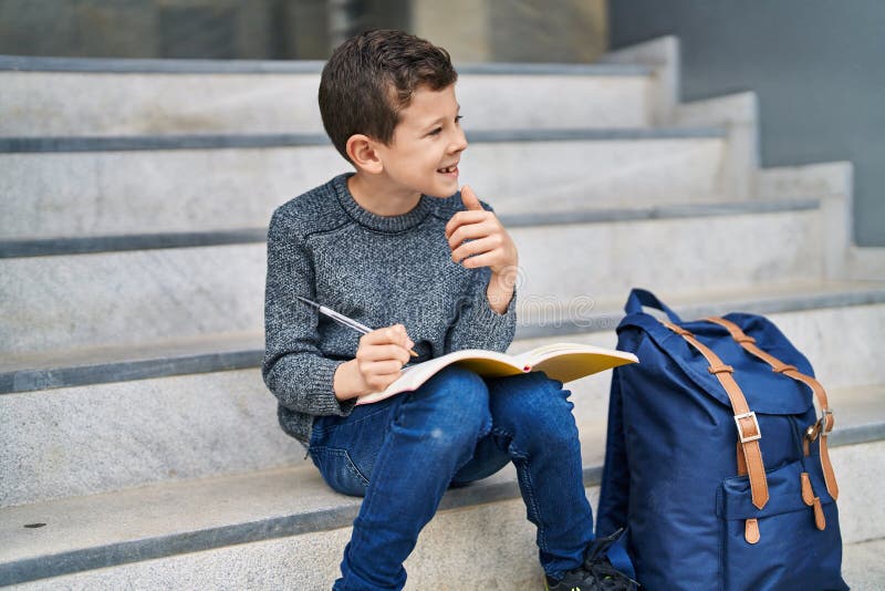 Blond Child Student Writing on Book Sitting on Stairs at School Stock ...