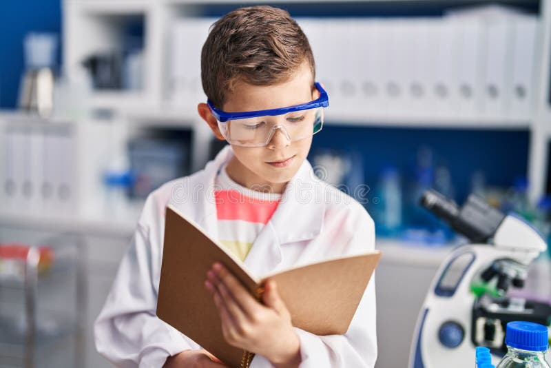 Blond Child Wearing Scientist Uniform Reading Book at Laboratory Stock ...