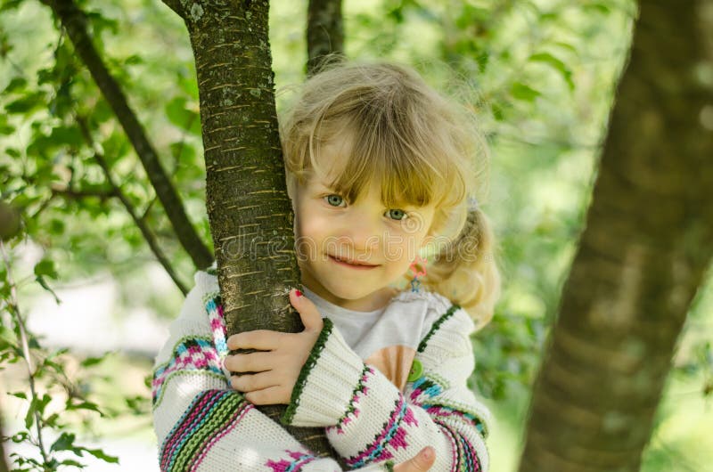 Blond girl stock image. Image of girl, limb, tree, outside - 230445475