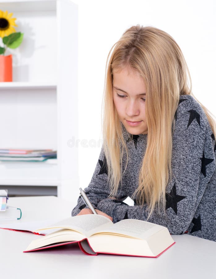 Blond girl doing homework stock image. Image of room - 68874875