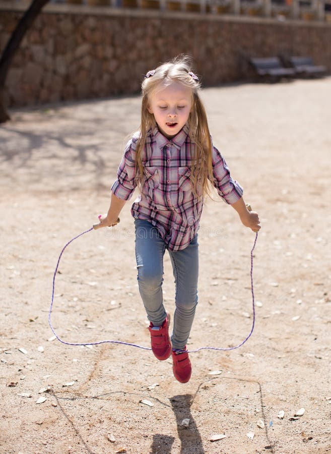 Blond girl jumping rope stock photo. Image of girl, laughing - 75951198