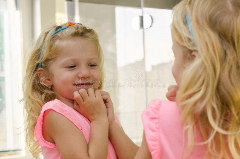 Blond Girl Smiling in the Mirror Stock Photo - Image of portrait ...