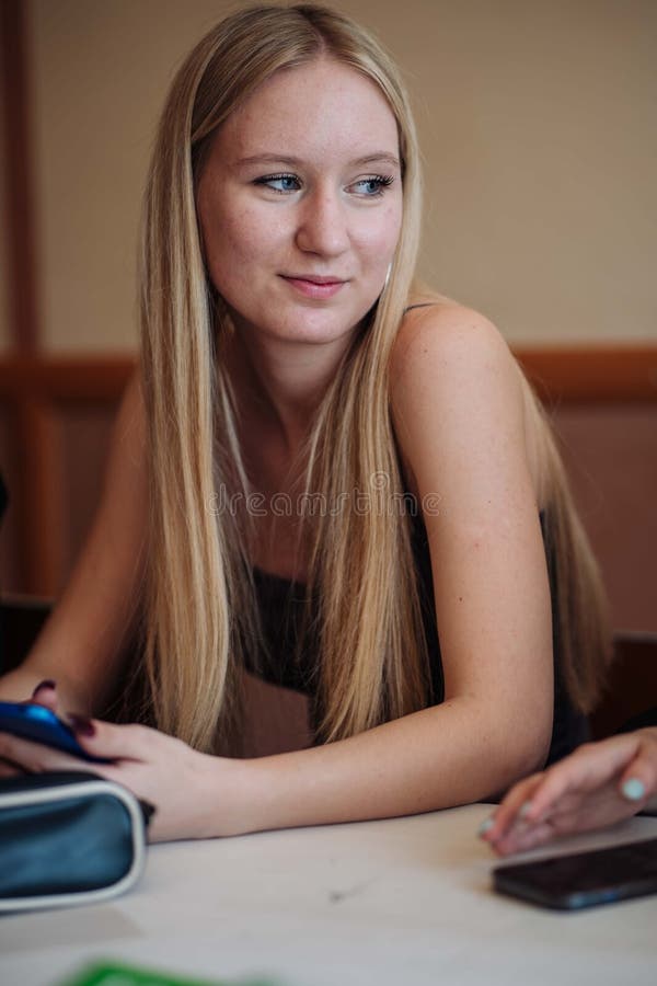 Blond High School Student Using Her Phone at Her Desk during Break Time ...