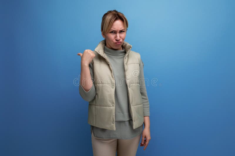 Blond Indignant Young Woman Shows Her Hand To the Side Stock Photo ...