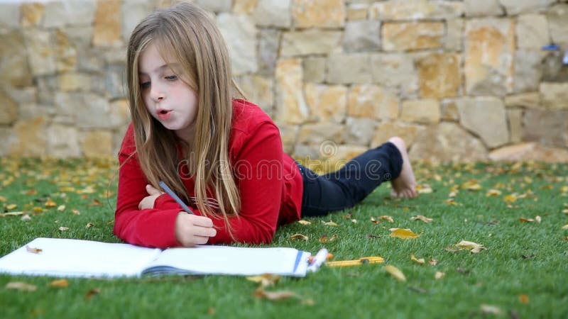 Blond Kid Girl Maths Homework Laying on Grass Counting with Fingers ...