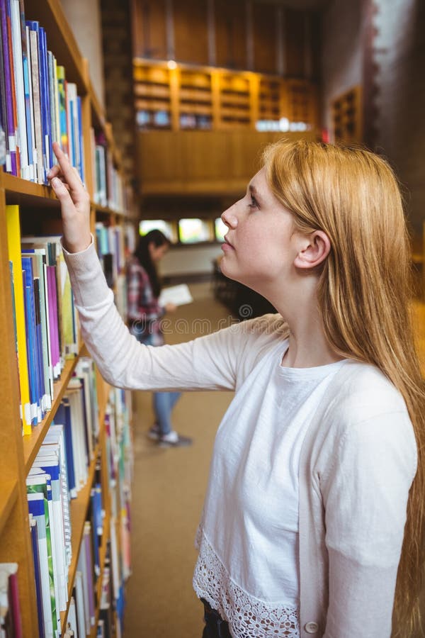 Blond Student Looking for Book in Library Shelves Stock Photo - Image ...