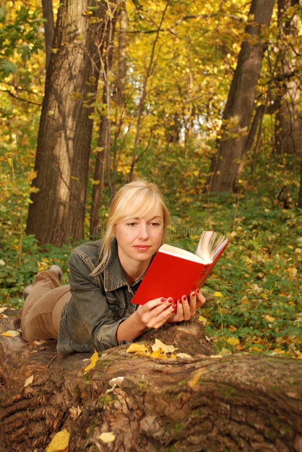 Blond Woman with a Book is Laying on the Tree Stock Photo - Image of ...