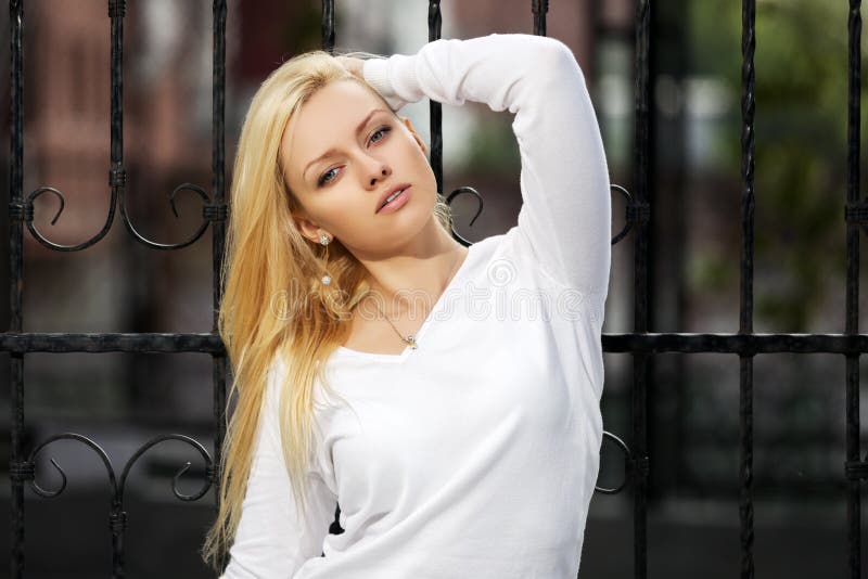 Blond Woman at the Cast Iron Fence Stock Image - Image of lady, fence ...